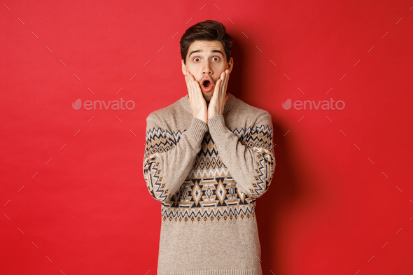 Image of surprised handsome guy reacting to cool new year promo offer ...