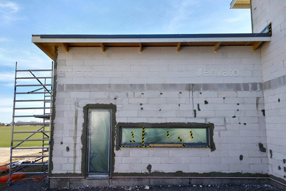 Facade of white block building under construction works. Stock Photo by ...