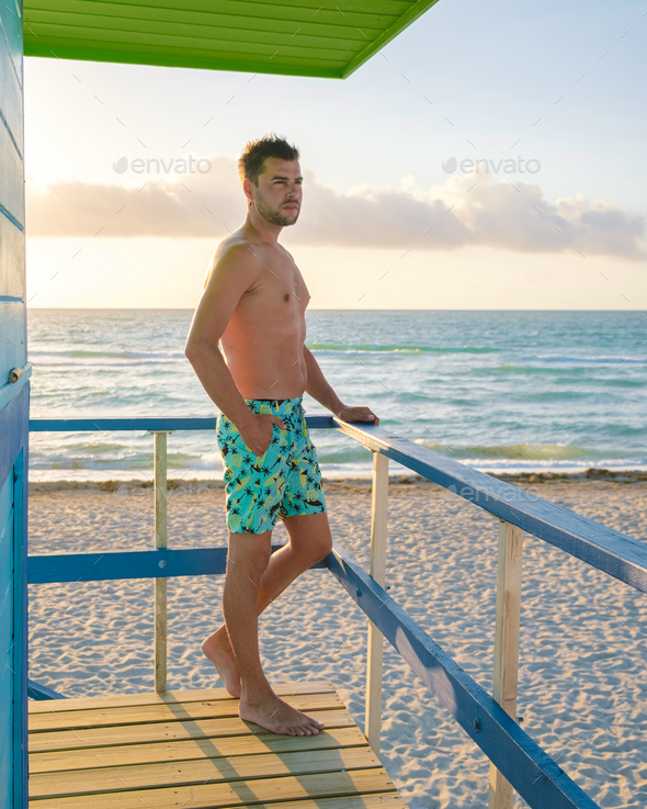Miami beach, young men on the beach at Miami beach, lifeguard hut Miami ...