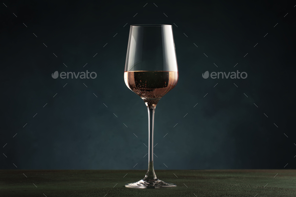Rose wine from the zinfandel variety in wine glass on dark background ...