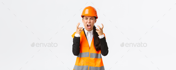 Mad and outraged asian female chief engineer, construction manager ...