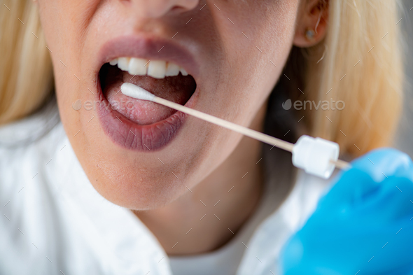 Inserting a swab into the mouth, collecting a saliva sample for DNA ...