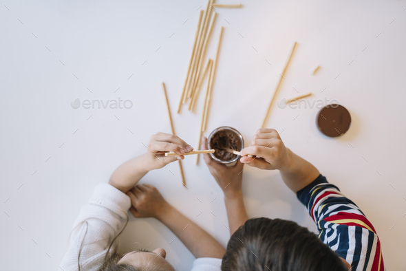 Two kids eating chocolate Stock Photo by karrastock | PhotoDune