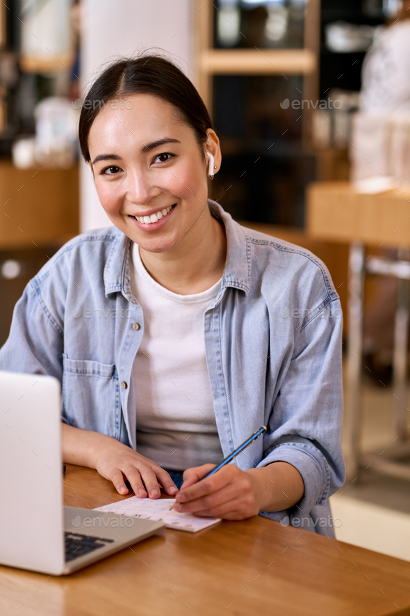 Young smiling Asian woman student elearning online using laptop. Stock ...