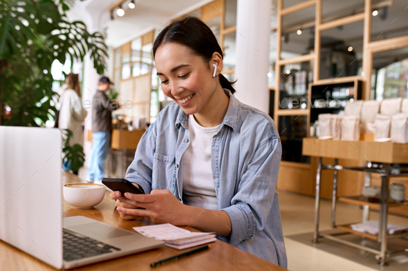 Young smiling Asian woman student using smartphone for elearning. Stock ...