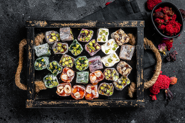 Turkish Delight Lukum, Oriental sweets with nuts and black tea. Black ...
