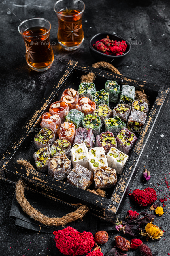 Turkish Delight Lukum, Oriental sweets with nuts and black tea. Black ...
