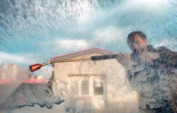 Man using water gun jet sprayer in car wash self-service Stock Photo by ...