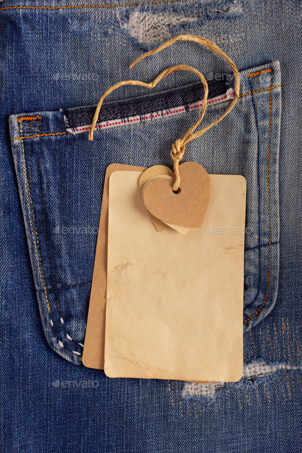 Paper price tag label on jeans background texture. Blue jeans denim ...