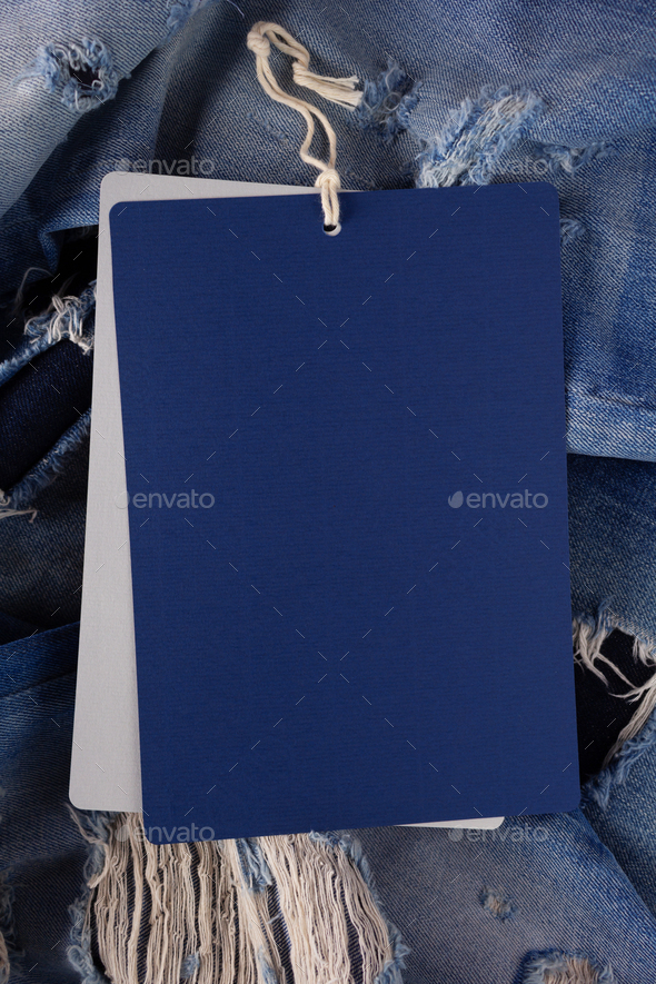 Paper price tag label on jeans background texture. Blue jeans denim ...
