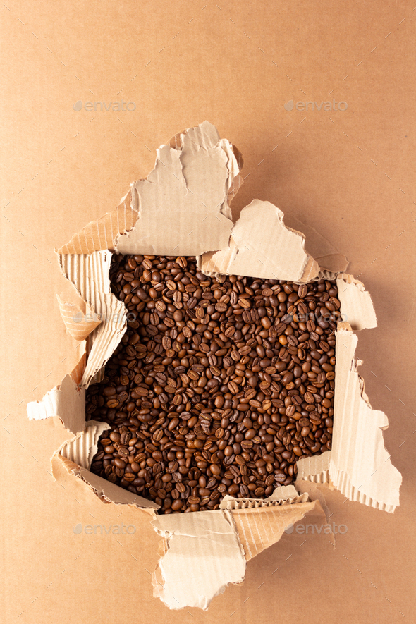 Coffee beans on torn package paper or cardboard. Coffee bean backround ...