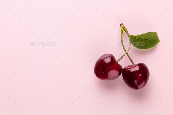Cherry berries on a pastel background top view. Background with a ...