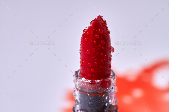 Close up red lipstick covered with water droplets. Stock Photo by ...
