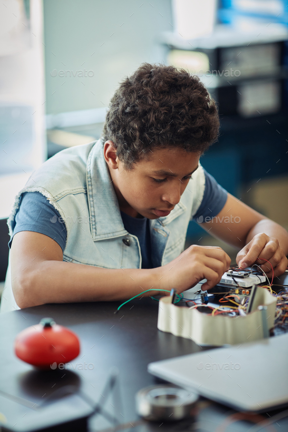 Boy in Robotics Class Stock Photo by seventyfourimages | PhotoDune