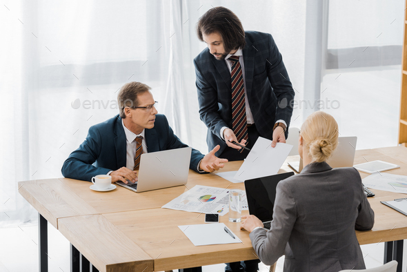 insurance agent showing contract to workers in office Stock Photo by ...