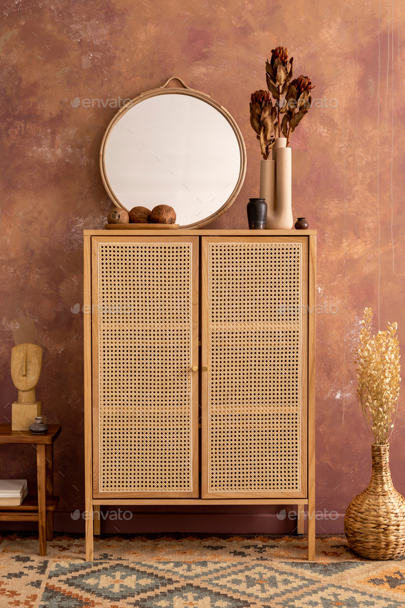 Stylish boho vintage dining room interior with rattan commode, round ...