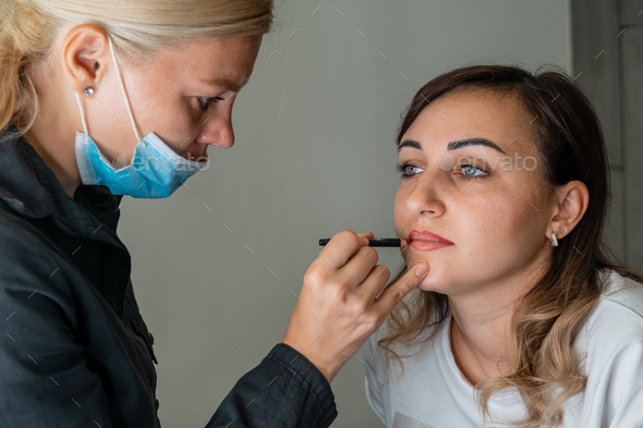 The process of makeup in the salon procedure lip contouring client ...