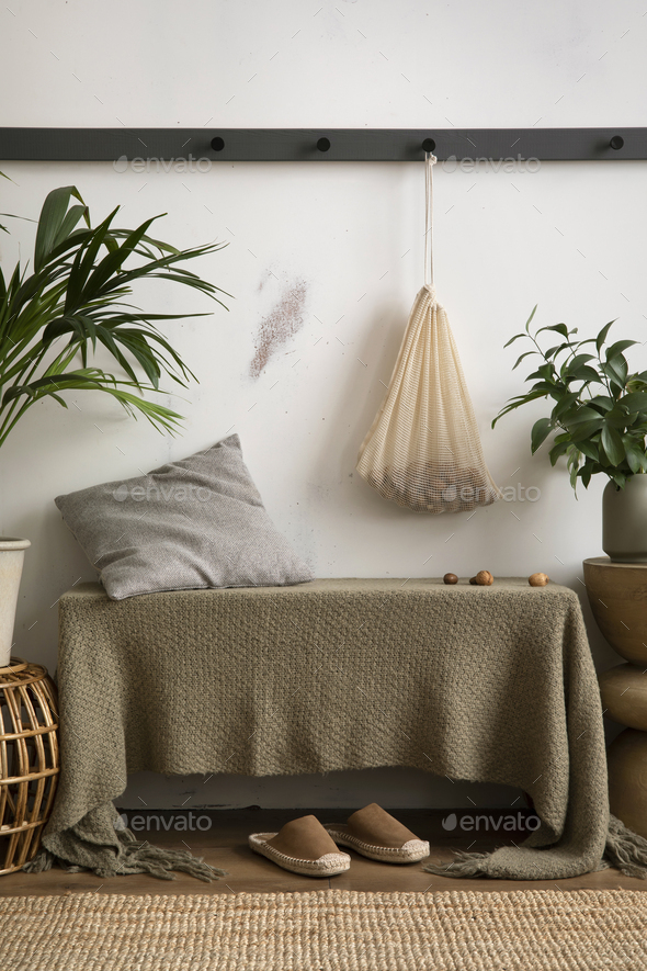 The stylish composition of cosy entryway with hanger, bench with green ...