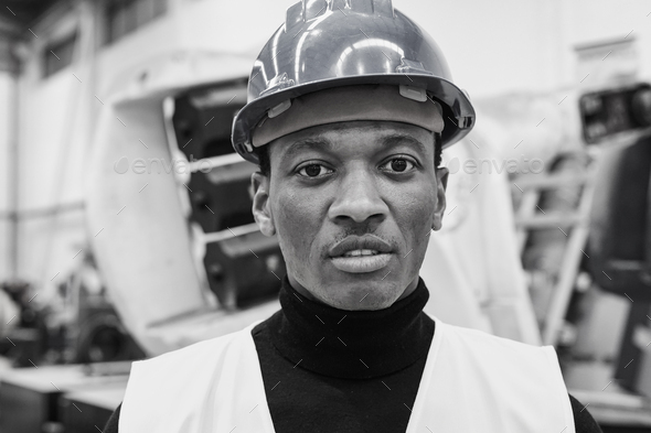 African engineer man looking on camera inside robotic factory Stock ...