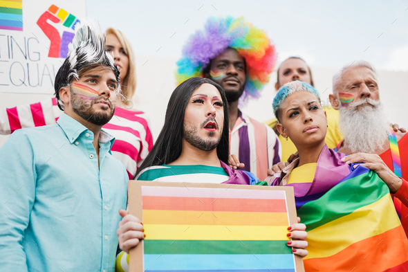Group of diverse gay people looking serious at pride parade ...