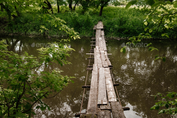 Old wooden bridge, wooden bridge across a small river, bridge with ...