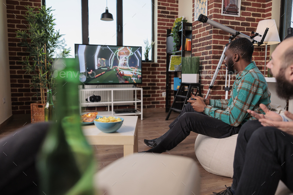 Multiethnic group of friends playing shooting video games Stock Photo ...