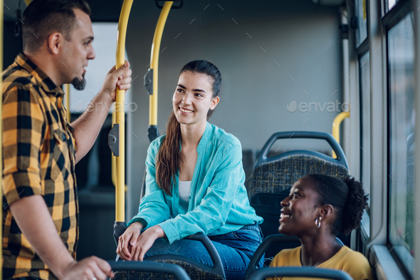 Multiracial group of friends talking while riding in a bus Stock Photo ...