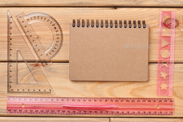 Flat lay of plastic rulers and spiral notebook. Stock Photo by ...