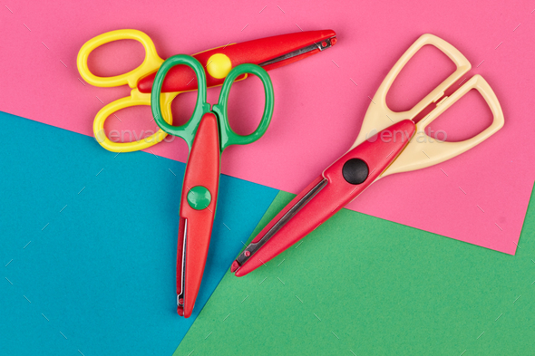 Three colorful scissors on color paper background. Stock Photo by ...