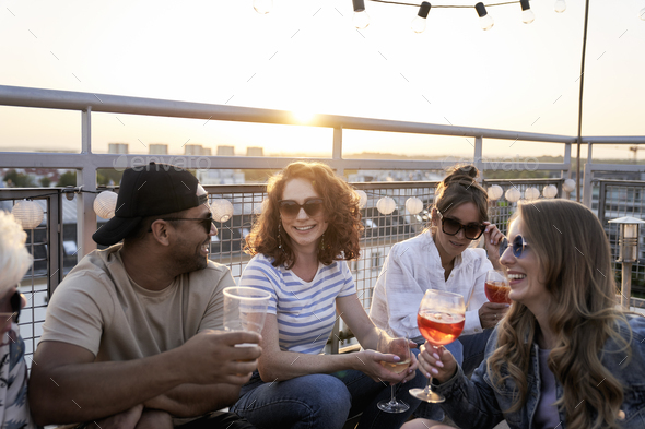 Group of friends at the rooftop party chilling together Stock Photo by ...