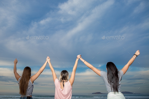 Happy friends holding hands up Stock Photo by Juan_Algar | PhotoDune