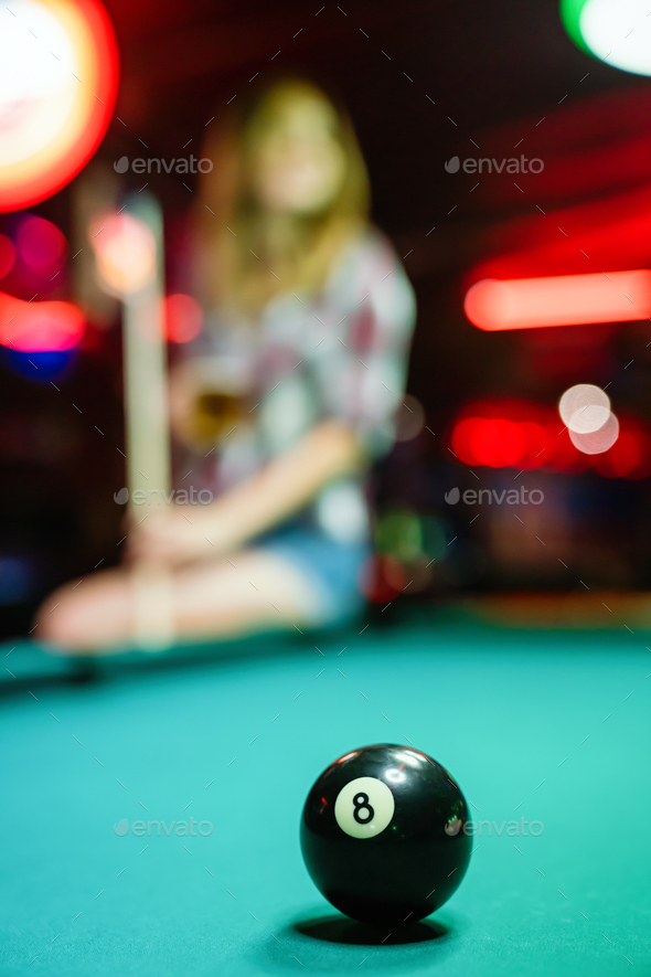 8 Ball from pool or billiards on a billiard table. People entertainment ...