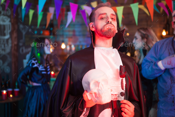 Young man dressed as vampire at Halloween party Stock Photo by DC_Studio