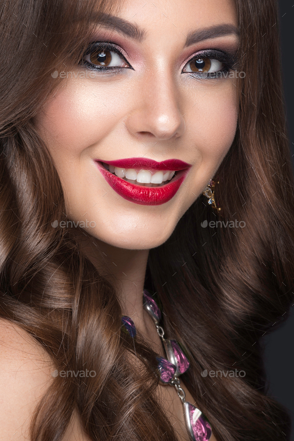 Beautiful woman with arabic make-up, red lips and curls. Beauty face ...
