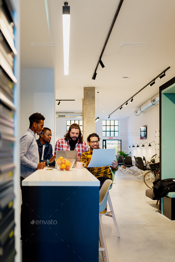 coworkers of different races in the workplace Stock Photo by Meniphoto
