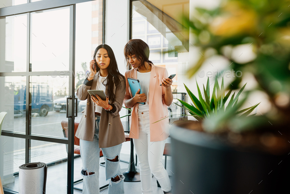 coworkers of different races in the workplace Stock Photo by Meniphoto