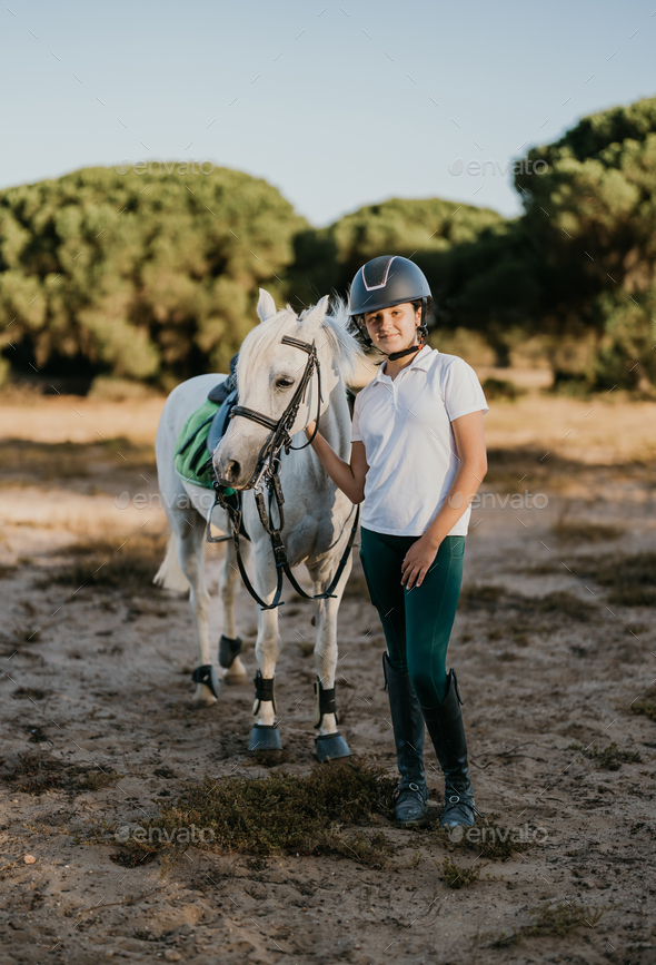 vertical portrait of 12 year old child rider with white pony Stock ...