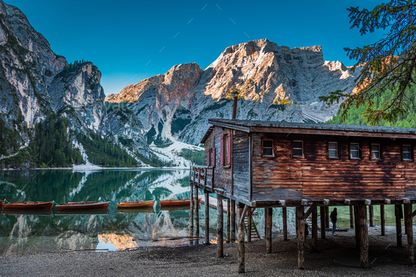 Old wooden hut and Lago di Braies at sunrise, Dolomites Stock Photo by ...