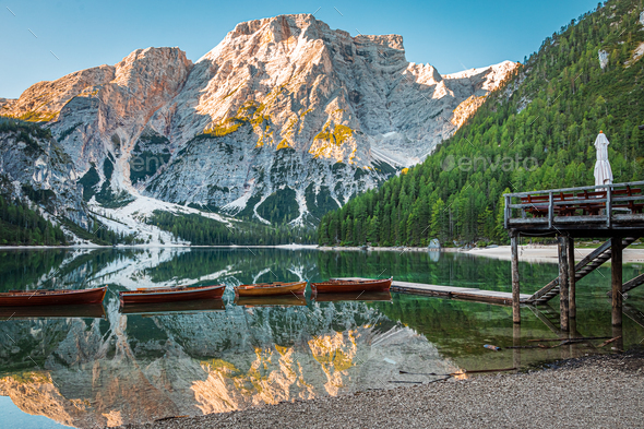 Lago di Braies and wooden boats in Dolomites, Italy Stock Photo by Shaiith