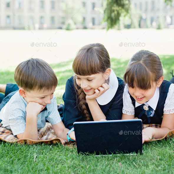 Group Of Elementary School Children Working Together on nature at park ...