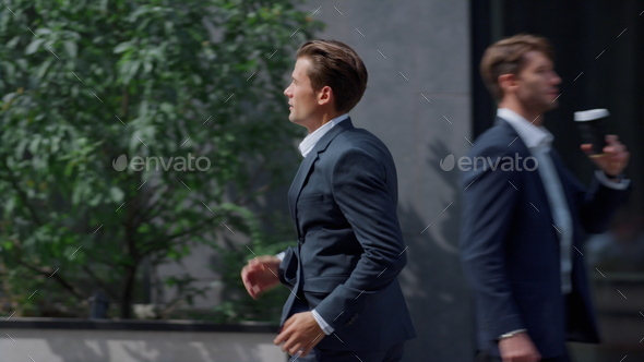 Serious finance worker running fast for work meeting in modern gray ...