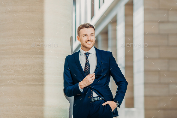 Shot of pleased successful male manager with bristle, wears formal ...