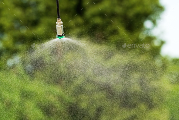 Agricultural sprinkler spraying water outdoors Stock Photo by ...