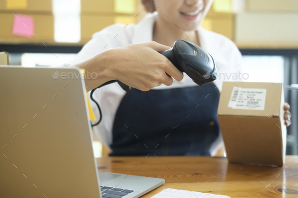 Young asian businesswoman use bar code scanner Scan the barcode on the ...
