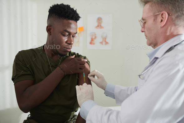 Military Officer Getting Injection Stock Photo by DragonImages | PhotoDune