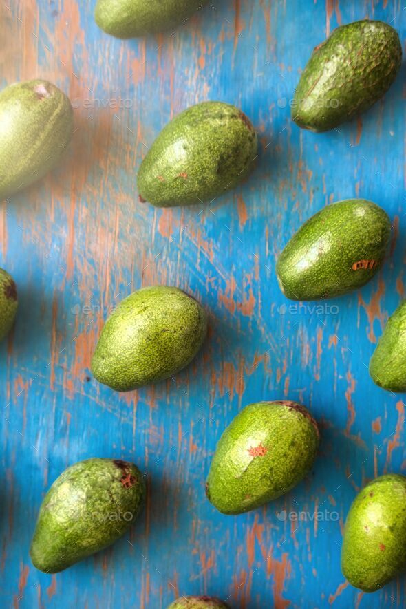 Avocados texture with blue vintage background Stock Photo by juanjomenta