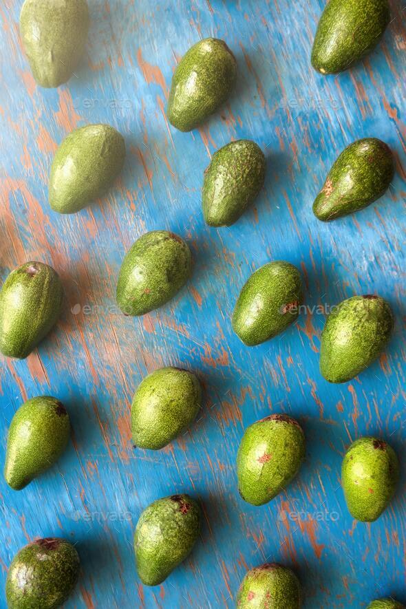Avocados texture with blue vintage background Stock Photo by juanjomenta