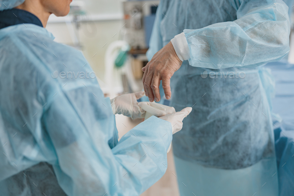 Close up of surgeon hands puts on gloves in the operating room ...