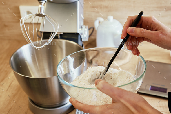 Woman pours flour into a mixer bowl Stock Photo by Lazy_Bear | PhotoDune