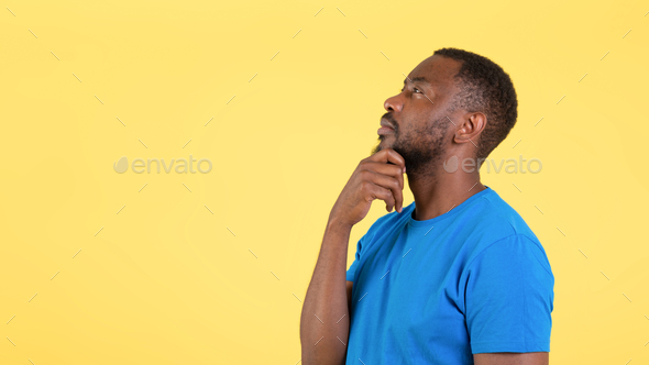 Side View Of Black Man Thinking Standing Over Yellow Background Stock ...